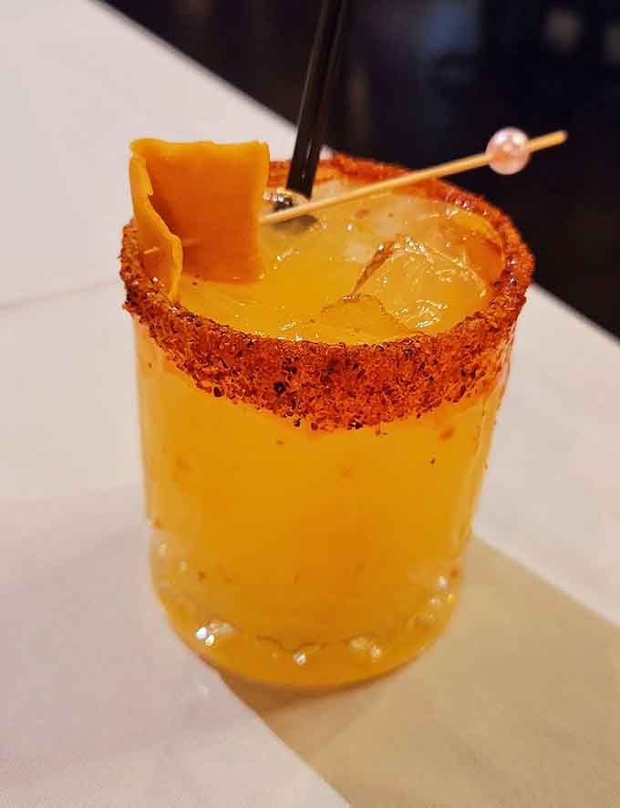 A cocktail with a spiced rim that means business, the kind of drink that makes you glad you're not driving.