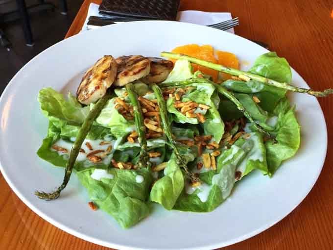 Grilled chicken perched atop greens so fresh they practically waved hello from the farm this morning.
