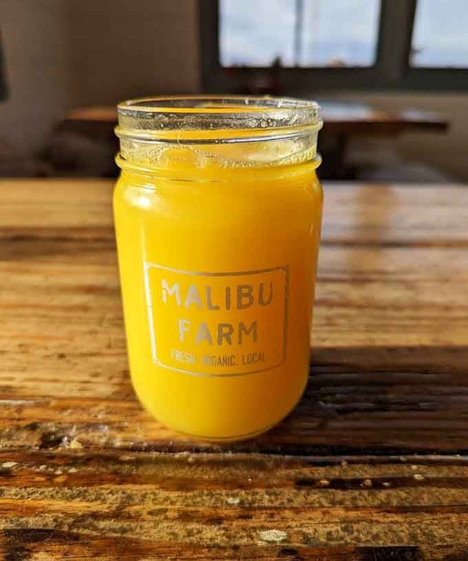 Fresh-squeezed orange juice glows golden in a mason jar, tasting like California sunshine in liquid form.