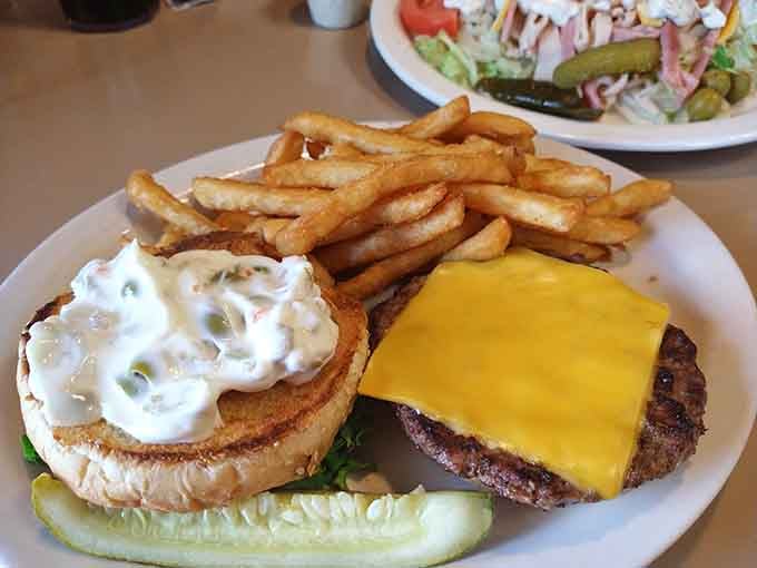 A burger so perfectly constructed it deserves its own architectural award, complete with golden fries for good measure.