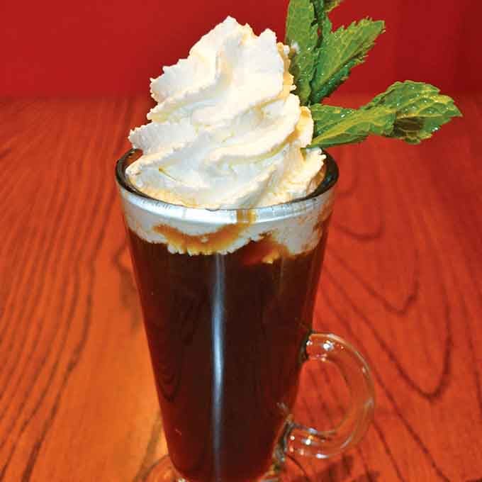Irish coffee topped with clouds of whipped cream, the perfect companion for deep breakfast conversations and lazy mornings.