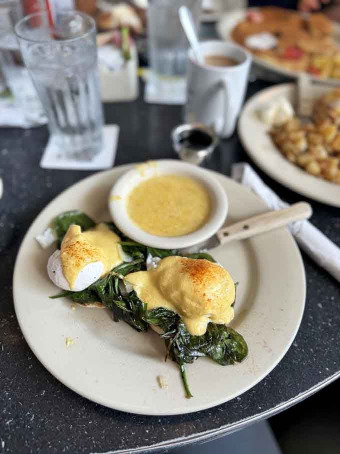Eggs Florentine proving that spinach and hollandaise make better partners than most celebrity couples these days.