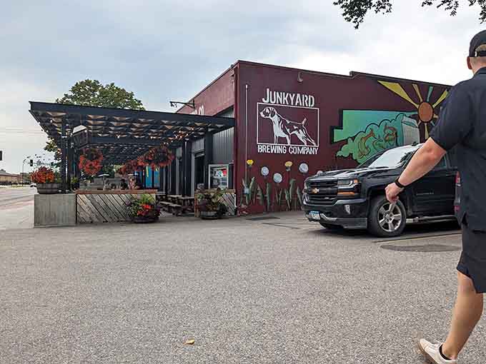 Junkyard Brewing Company welcomes visitors with colorful murals and outdoor seating, where craft beer meets community gathering perfectly.