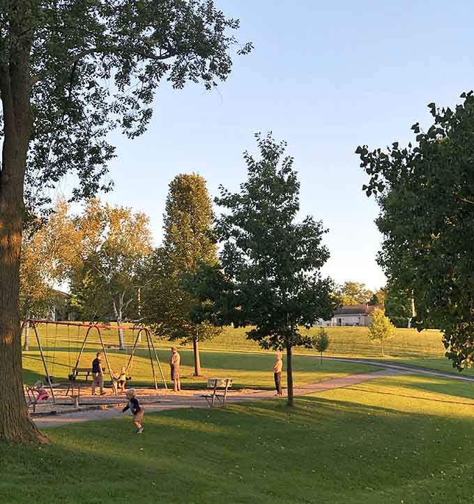 Golden hour at the park, where simple swings and open grass remind us that joy doesn't require complications.