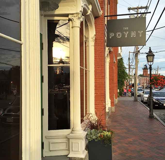 The Poynt's classical columns frame the entrance with architectural elegance that elevates your dining experience before you even step inside.