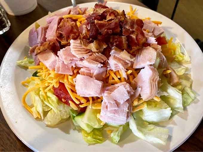 This chef salad doesn't mess around, piling ham, turkey, bacon, and cheese like it's building a delicious skyscraper.