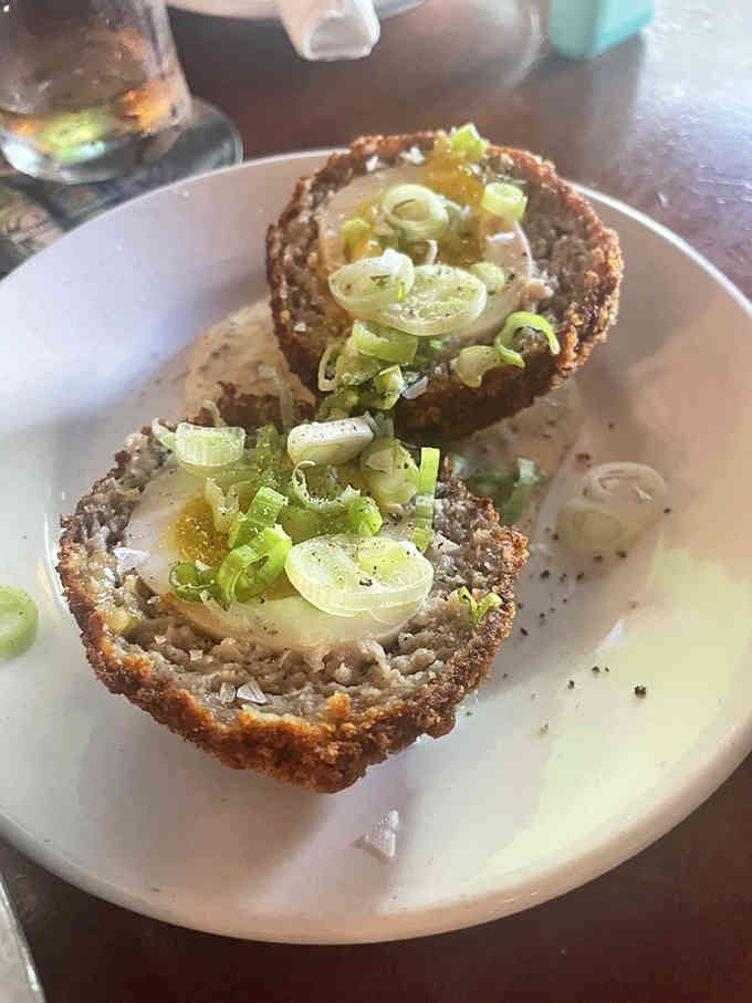 Scotch eggs sliced open reveal their glorious layers like a delicious geological formation worth studying and devouring.