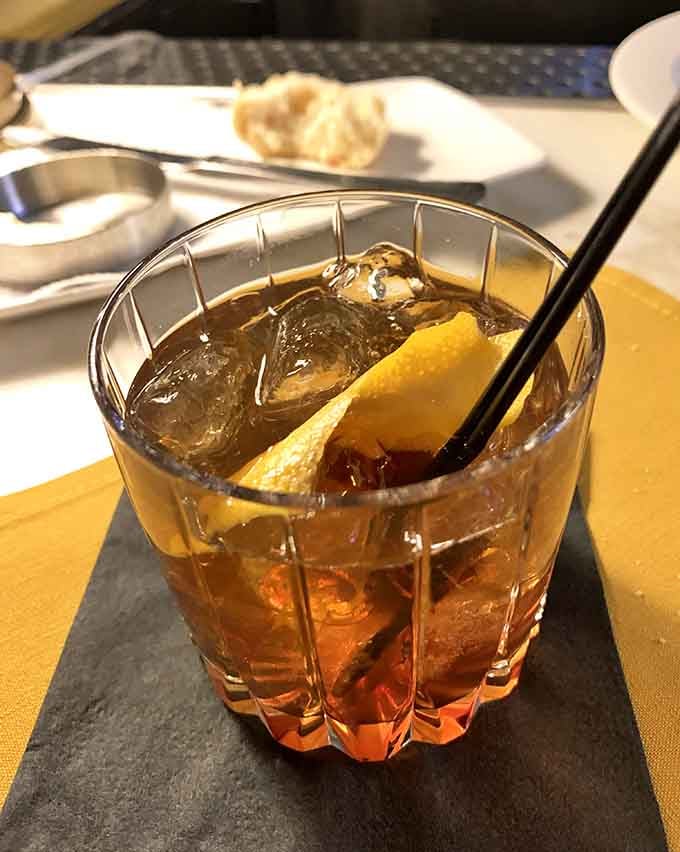 A perfectly crafted old fashioned with a generous orange twist, the ideal companion for your steak dinner.