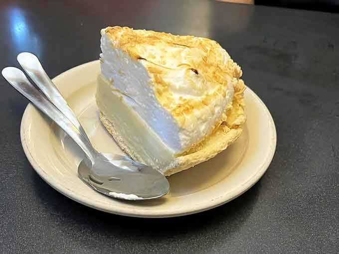 That towering slice of coconut cream pie stands taller than most people's breakfast ambitions and tastes like pure heaven.