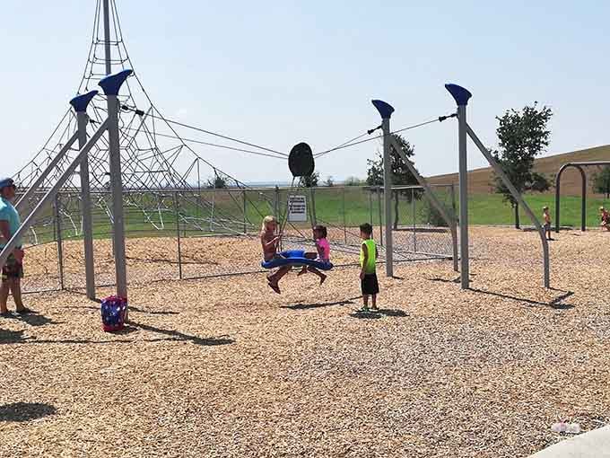 That rope swing attracts lines of eager participants, each waiting their turn to fly through the air.