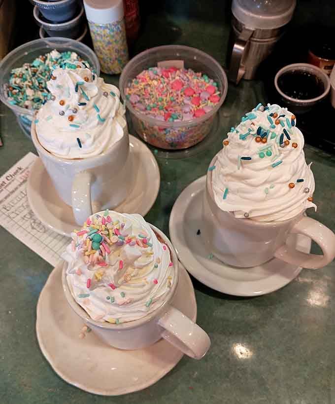 Hot chocolate topped with whipped cream mountains and sprinkles, because adults deserve fun drinks too, darn it.