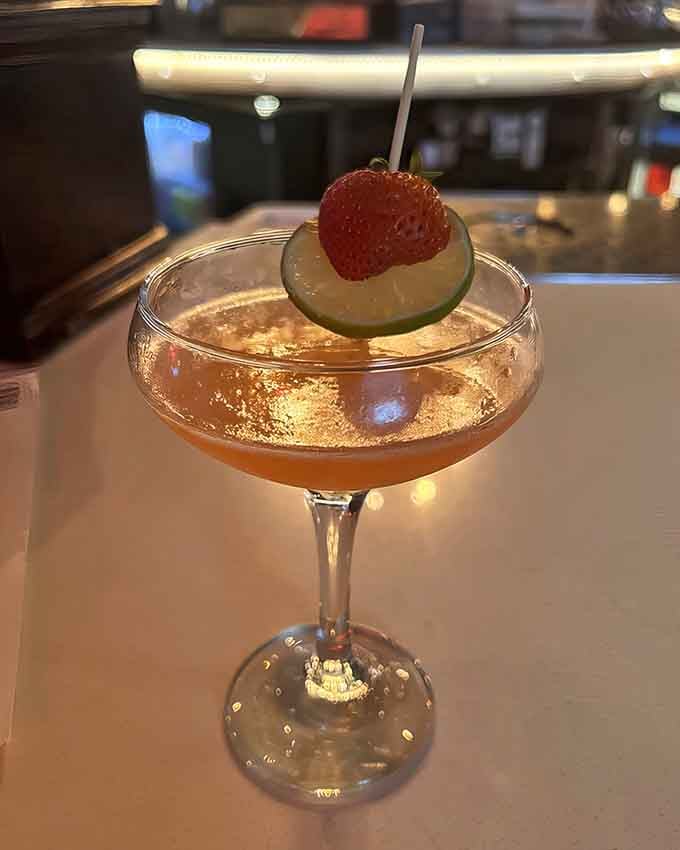 A strawberry daiquiri garnished with style, because sophistication and shuffleboard aren't mutually exclusive after all.