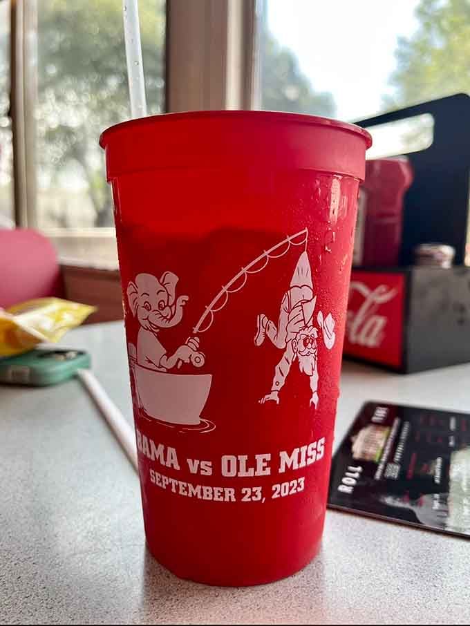 Even the cups wear crimson and celebrate game day, because in Tuscaloosa, everything is a potential football reference waiting to happen.