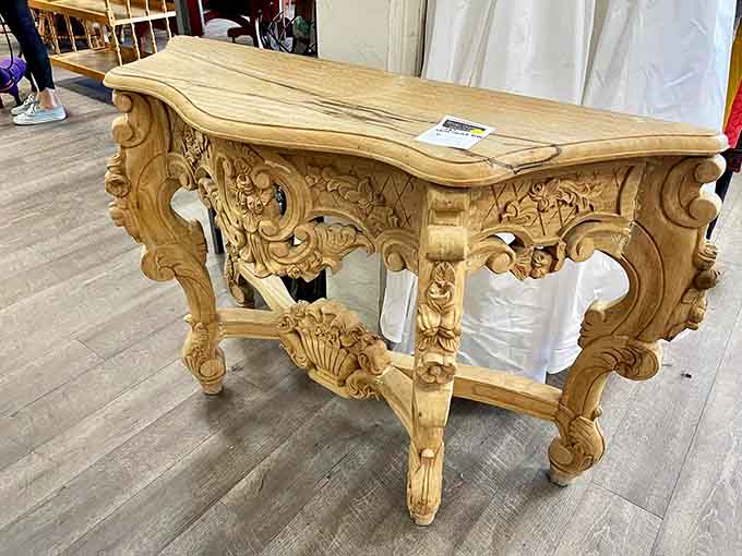 This ornate carved table looks like it escaped from a French palace and landed here for inexplicably affordable adoption.
