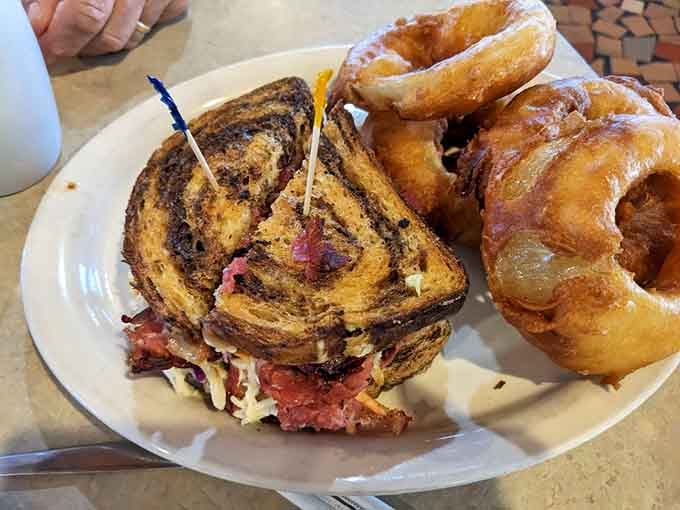 That perfectly grilled Reuben paired with golden onion rings is the kind of lunch that makes everything right with the world.