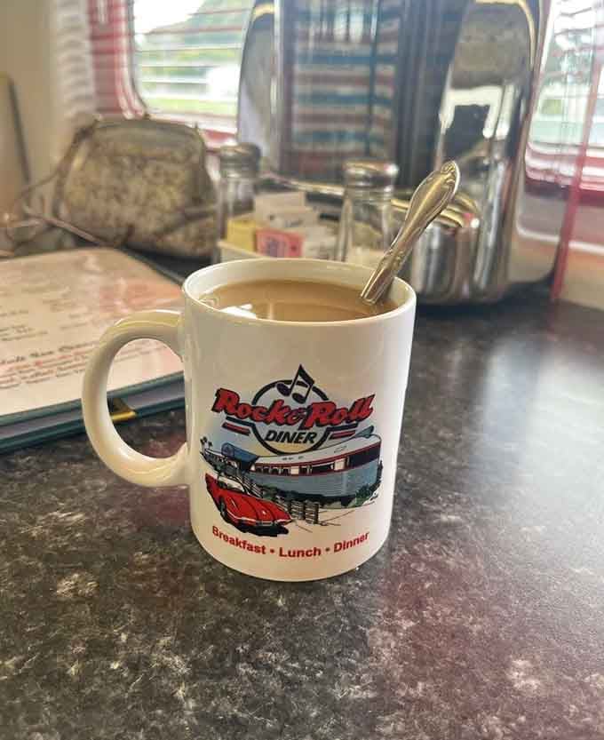 Hot coffee in a souvenir mug with chrome napkin dispensers nearby captures the essence of classic American diners.