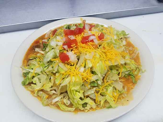 This tostada is piled so high with toppings, it's basically a delicious edible skyscraper on your plate.