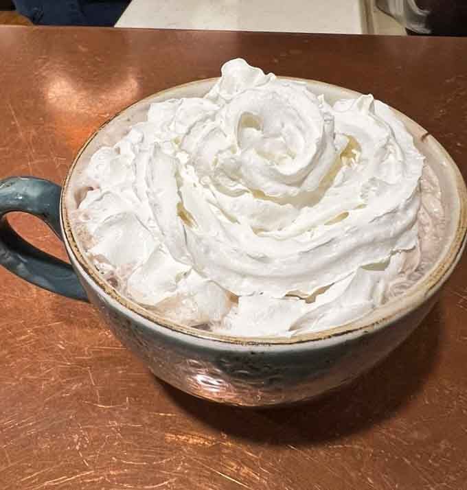That mountain of whipped cream on hot chocolate proves some people understand the assignment perfectly well.