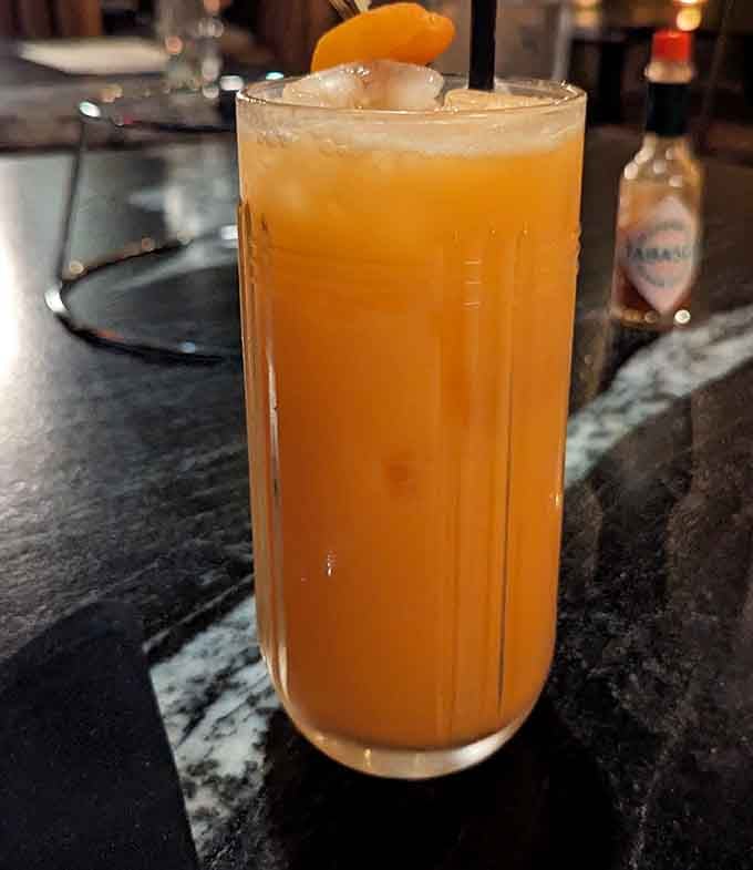 This citrus-hued cocktail looks like liquid sunshine decided to take a vacation in a glass.