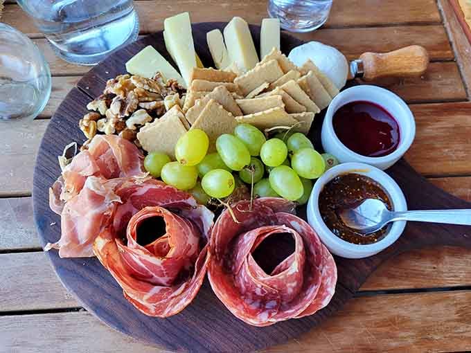 Charcuterie boards done right: prosciutto roses, aged cheeses, and accompaniments that understand the assignment perfectly&mdash;no sad crackers here.