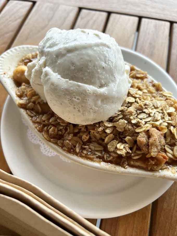 Apple crumble topped with ice cream, because sometimes dessert needs to remind you why life is worth living.