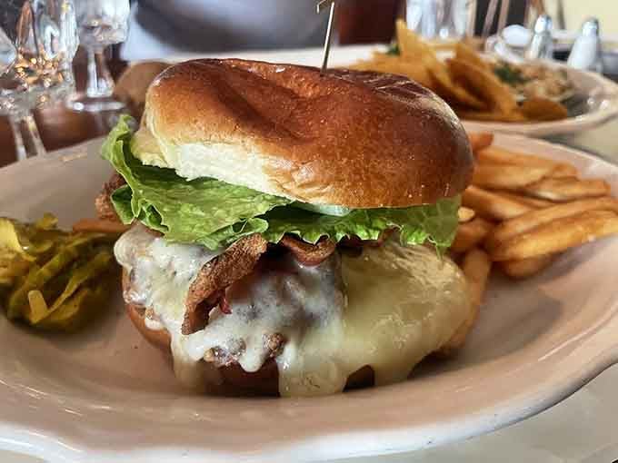 A burger topped with bacon and melted cheese that could make a vegetarian reconsider their entire life philosophy.