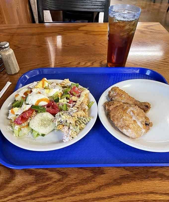 That loaded salad with eggs, bacon, and fresh vegetables proves even the healthier options get serious attention here.
