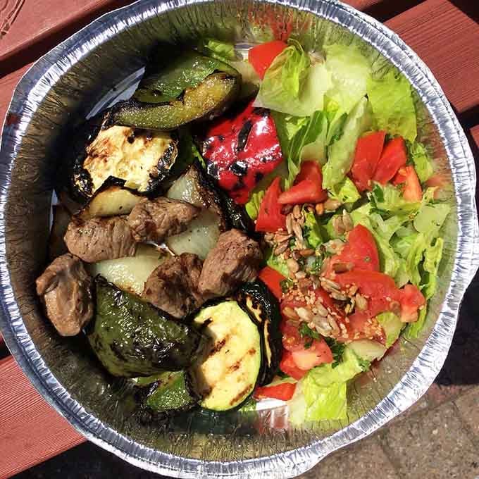 Grilled lamb over greens with roasted vegetables&mdash;this is what happens when kebabs decide to get fancy and healthy.