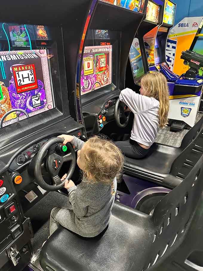 Racing simulators let kids pretend they're old enough to drive while parents remember when quarters bought serious arcade time.