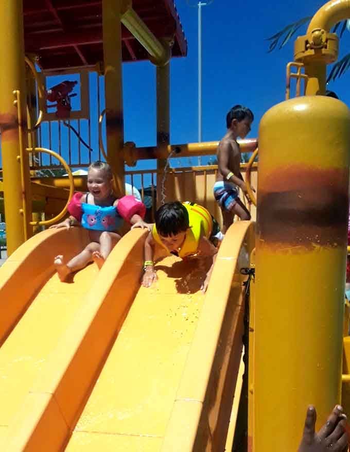 Three kids, three slides, zero complaints about being bored; that's what we call a parenting victory.