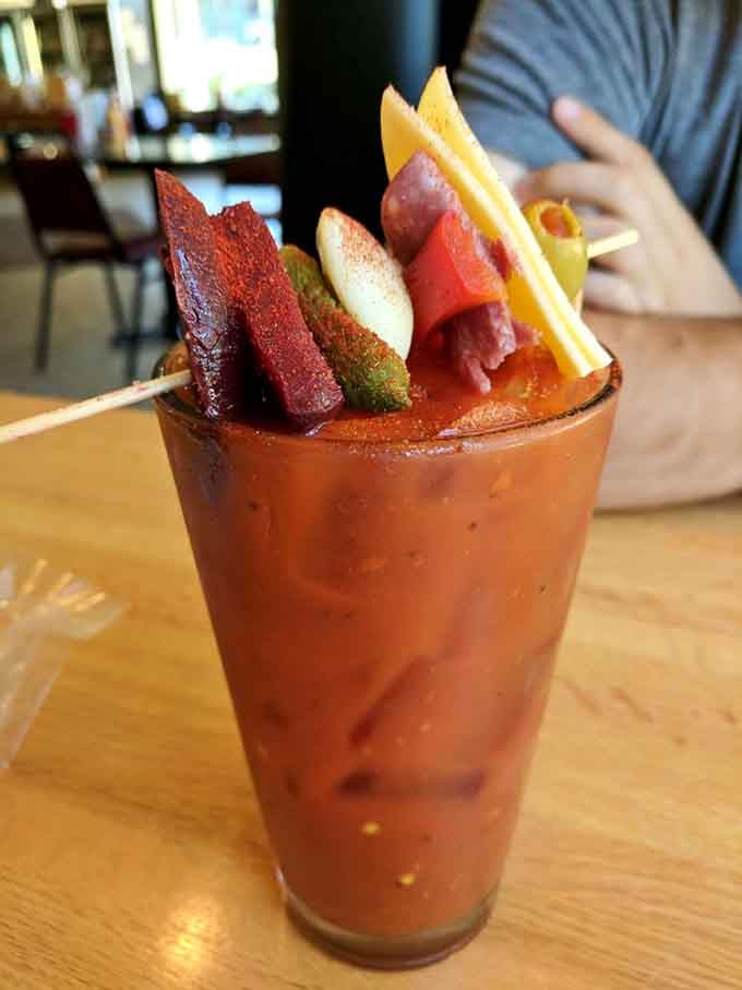 This Bloody Mary comes loaded with enough garnishes to qualify as both drink and appetizer simultaneously, honestly.