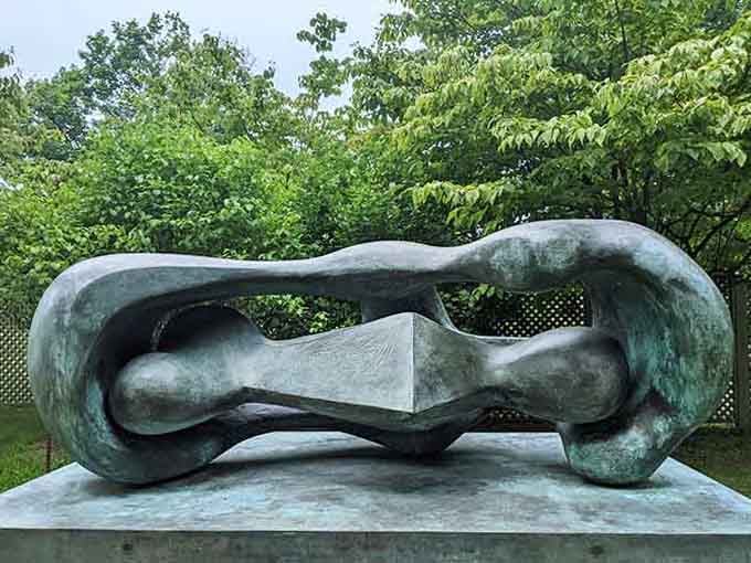 Smooth bronze curves that flow like frozen water, inviting contemplation from every angle you choose.