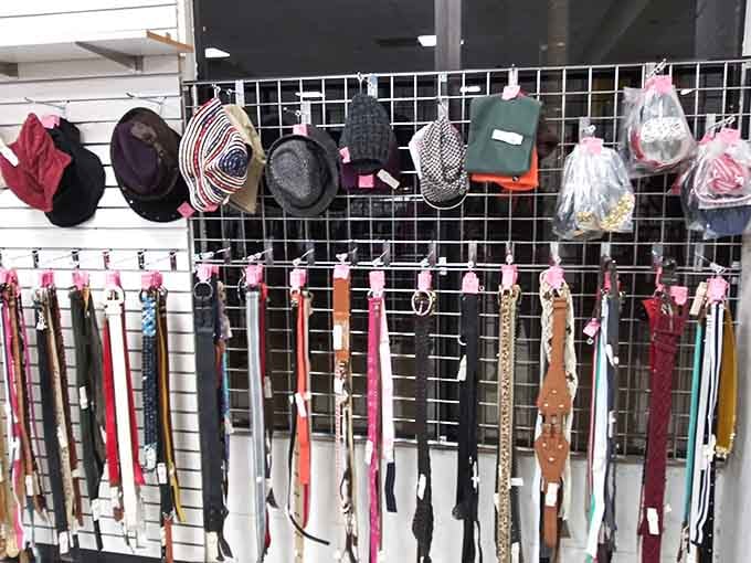 Belts hanging like a leather goods convention where everything's actually affordable for once.