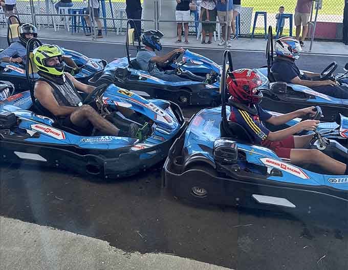 Helmets gleaming in the sun, these racers sit poised and focused like astronauts awaiting launch from their low-slung cockpits.
