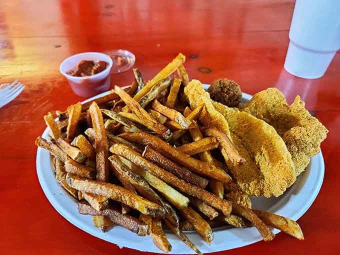 Golden fried fish and a mountain of fries create a plate that understands the assignment perfectly.