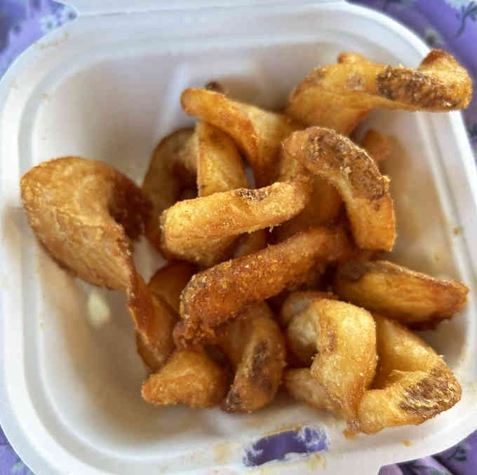 Golden, crispy fries that curl like they're waving hello, seasoned to that perfect just-right level of deliciousness.