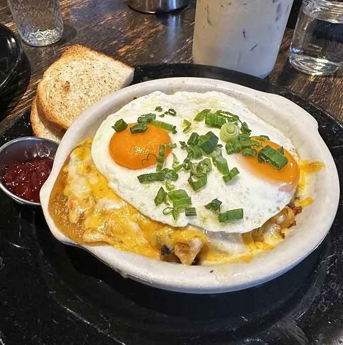 Sunny-side eggs crowning a skillet of melted cheese and savory goodness will make you reconsider your usual breakfast order.