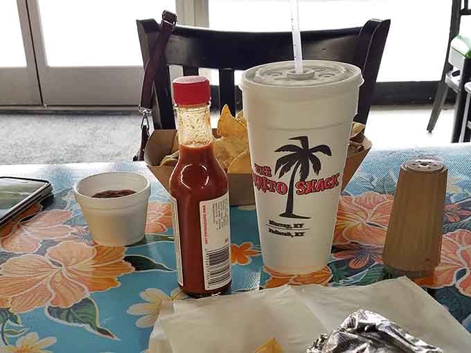 The branded cup with hot sauce standing guard means you're about to experience a meal that takes hydration seriously.