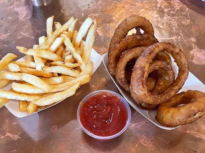 Golden fries and onion rings proving that sometimes the supporting cast deserves equal billing and applause.