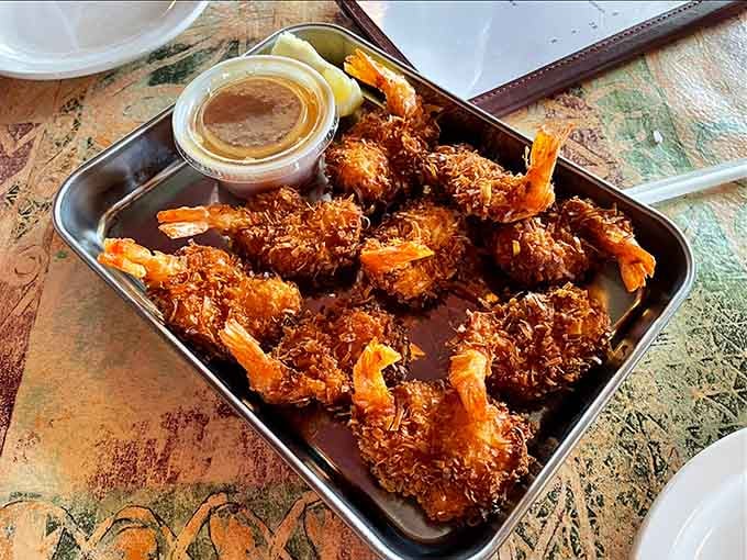 Golden coconut shrimp piled high like edible treasure proves the ocean's bounty travels well, even to the heartland.