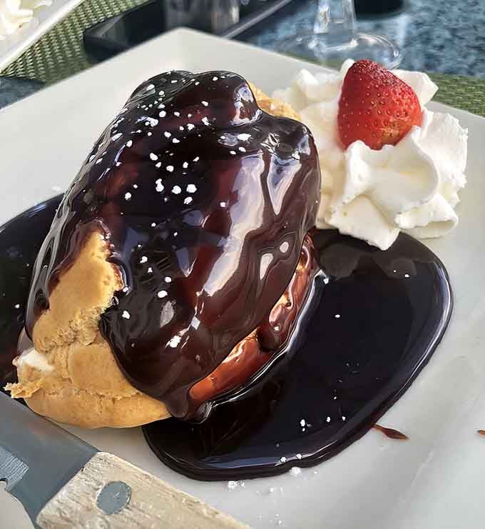 That chocolate-drizzled frozen éclair with whipped cream is dessert doing exactly what dessert should do: making you smile.