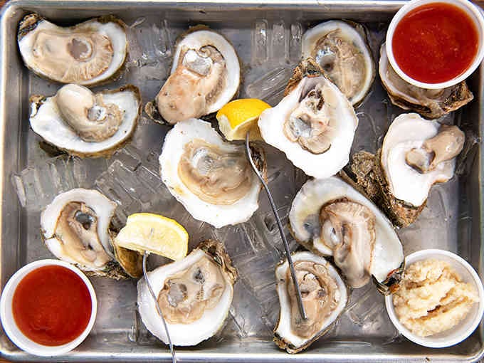 Fresh Gulf oysters on ice, glistening like edible treasures that somehow found their way to landlocked Kentucky.
