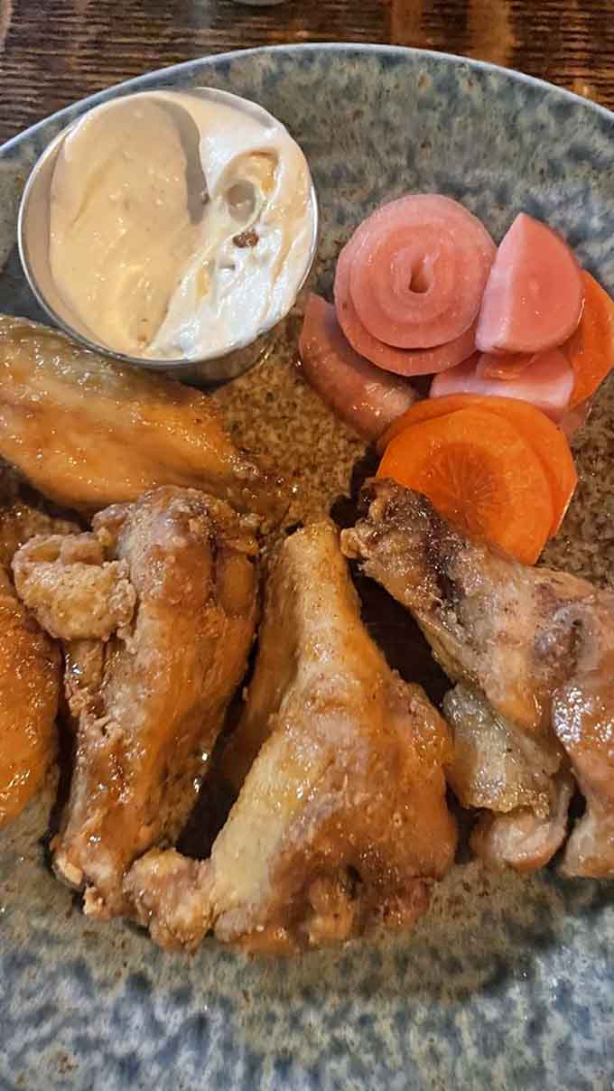 Wings glazed to glistening perfection, the kind that make you forget napkins exist until it's too late.