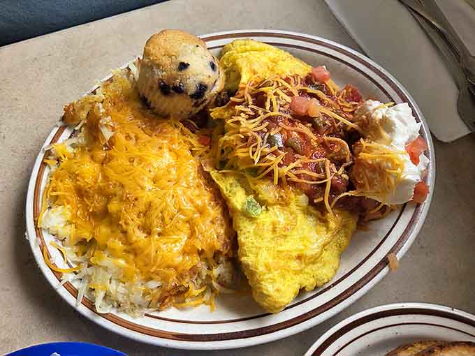 That omelet's so fluffy it could double as a pillow, surrounded by hash browns that deserve their own fan club.