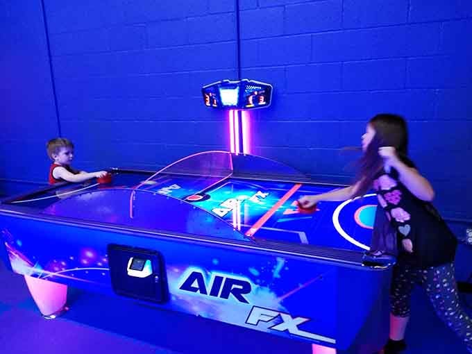 Air hockey under cosmic glow turns simple games into intergalactic battles, puck flying like a meteor.