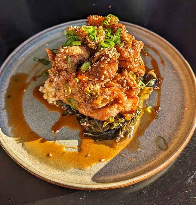 Crispy chicken perched on greens like it's posing for its close-up, and honestly, it's earned the attention.