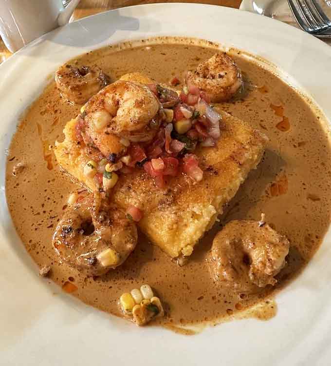 Shrimp and Grit Cakes swimming in sauce prove Southern comfort food belongs on every bucket list.