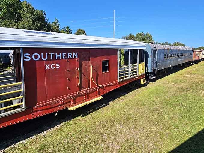 The Southern Railway caboose sits proudly in the sunshine, ready to share stories of miles traveled and cargo hauled.