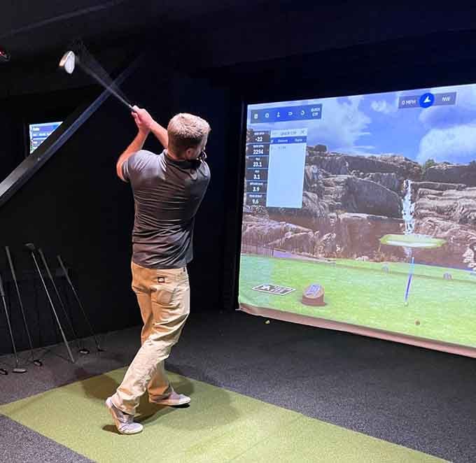 The simulators let you play world-class courses without the airfare, dress code, or judgmental caddies watching your swing.