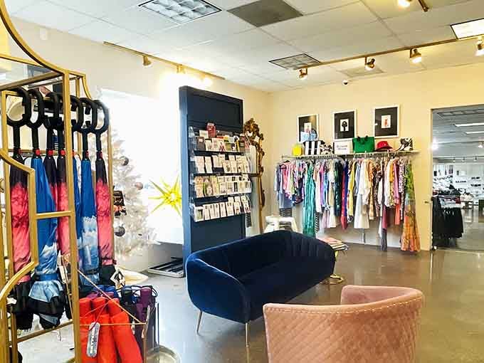 Velvet seating and track lighting create an inviting atmosphere where browsing designer clothing feels like visiting a friend's very wealthy closet.